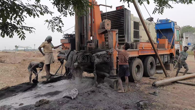 A Laborer is Tying the Borewell Drilling Pipe with a Rope and Getting ...