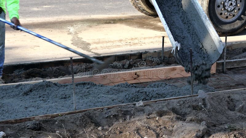 Labour Builders at Construction Site Filling Formwork with Cement ...