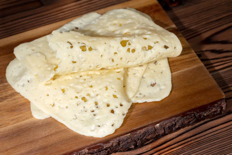 Lace Cheese Sliced on Cutting Board Stock Image - Image of farm, eating ...