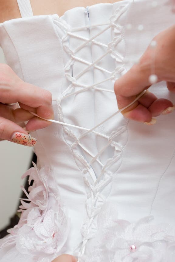 Lacing up a wedding dress stock photo. Image of bridal - 4346012
