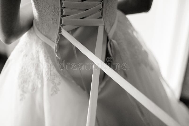 Lacing the wedding dress. stock photo. Image of back - 151971148