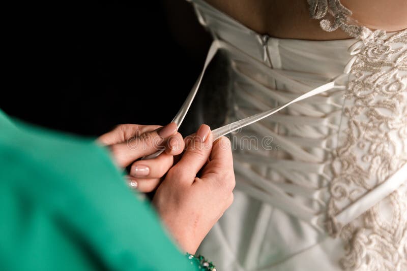 Lacing the wedding dress. stock image. Image of corset - 151971293