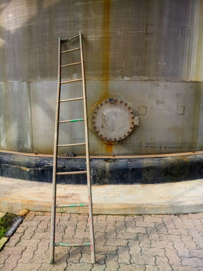 A Ladder Made Leaning on a Storage Tank Wall Stock Photo - Image of ...