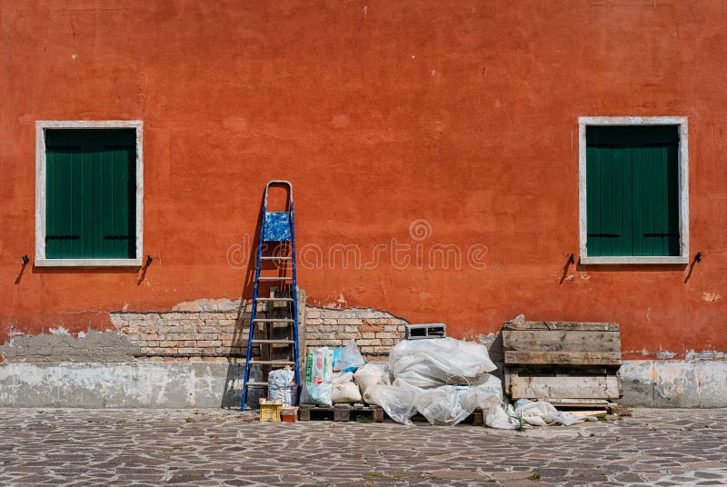 An Intense Orange Wall with a Ladder Editorial Photo - Image of street ...