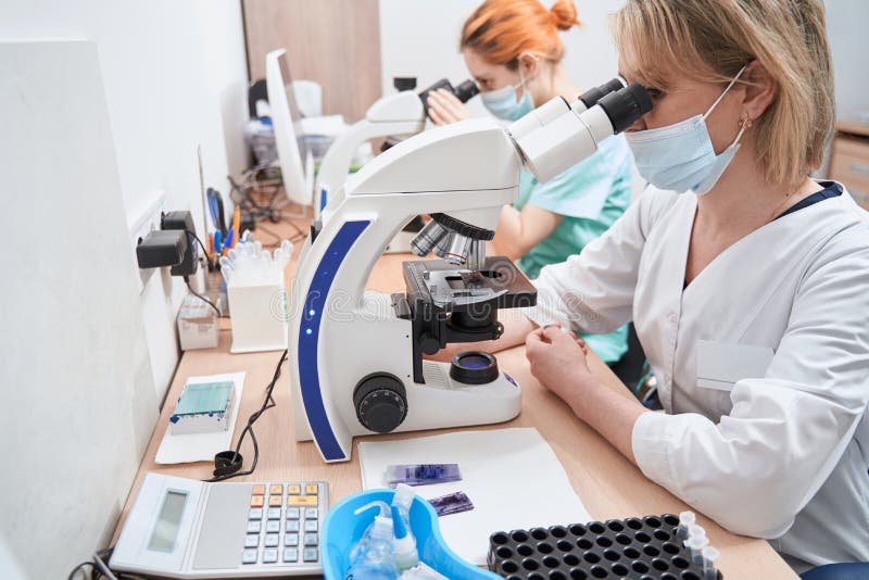 Medical Workers in the Laboratory with Microscopes Stock Image - Image ...