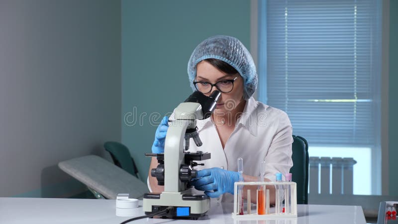 Lady Adjusts Microscope Working with Sample in Hospital Stock Video ...