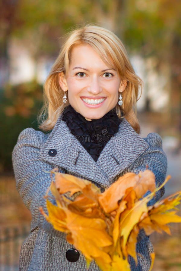 Lady with autumn leaves. stock image. Image of healthy - 60569307