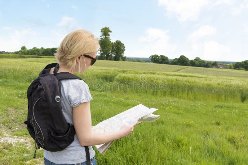 Lady with Backpack Holding and Reading Map in Grass Field Stock Image ...
