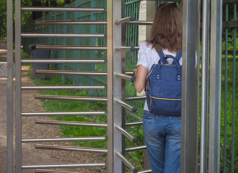 Lady with a Backpack Turnstiles in a Private Park. Stock Photo - Image ...