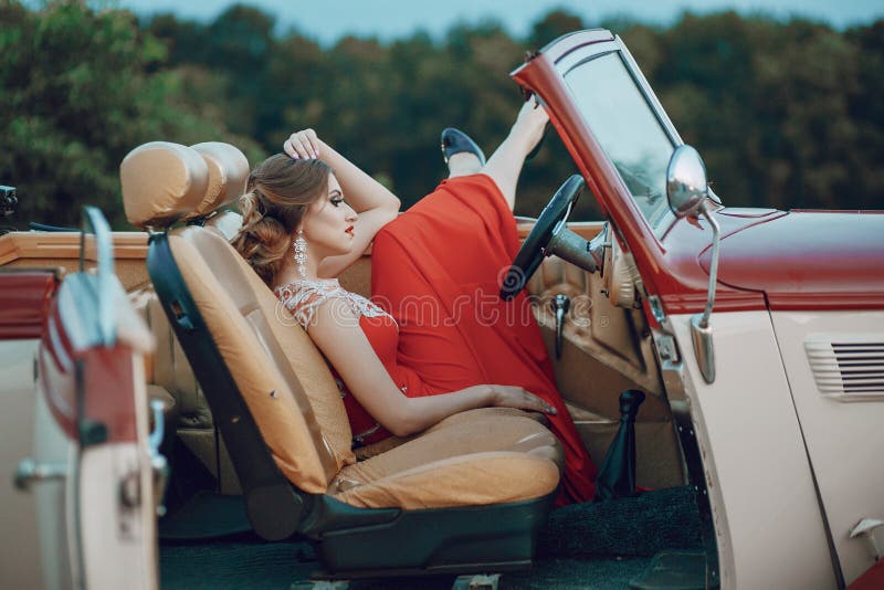 Lady in a car stock image. Image of long, female, dress - 121522277