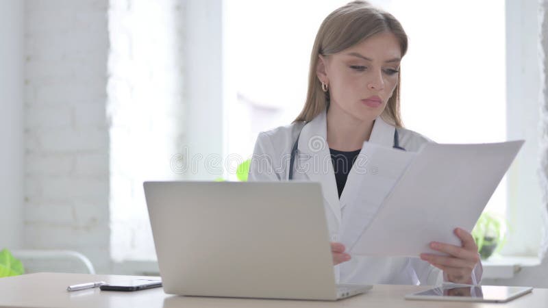 Lady Doctor Doing Paperwork in Clinic Stock Photo - Image of ...
