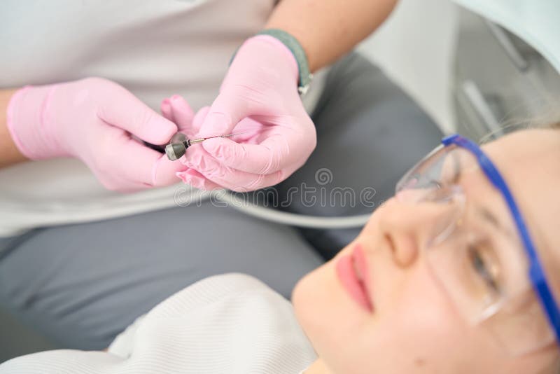 The Doctor Inserts a Needle into the Thigh. Intramuscular Injection ...