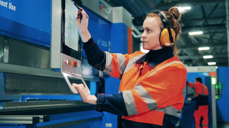 Lady Engineer is Navigating a Display of an Industrial Machine Stock ...
