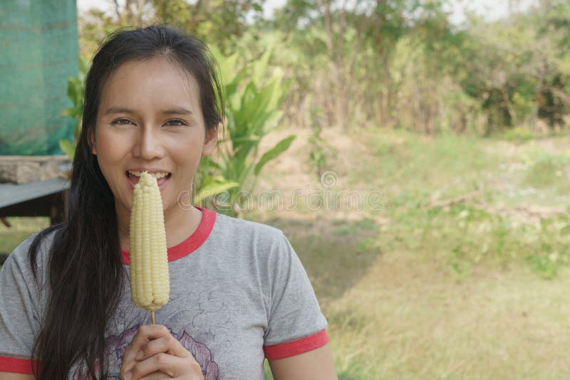 A Lady is Going To Eat Corn Stock Image - Image of natural, lady: 211458321