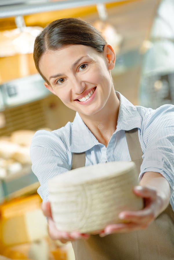 Lady holding cheese stock photo. Image of work, aisle - 258549142