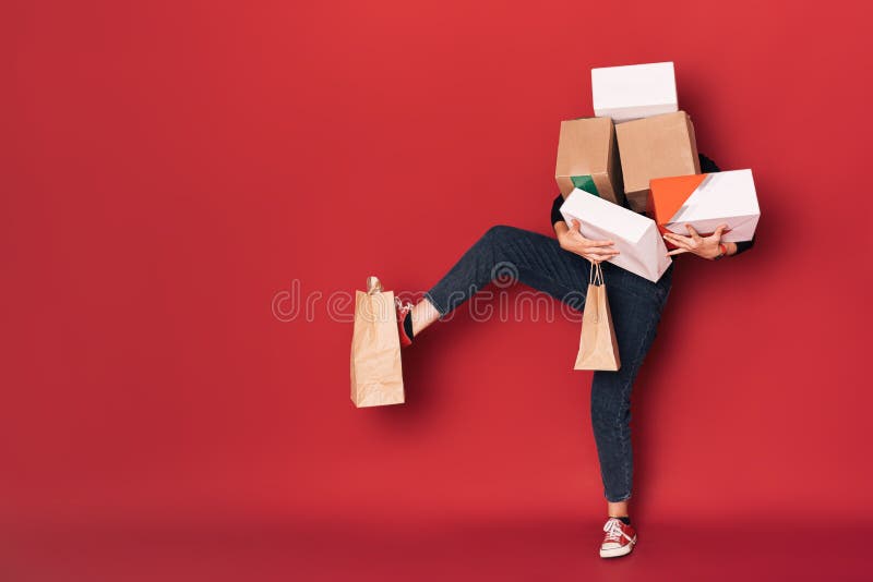 Lady Holding a Mountain of Boxes in Her Hands and a Paper Bag Hanging ...
