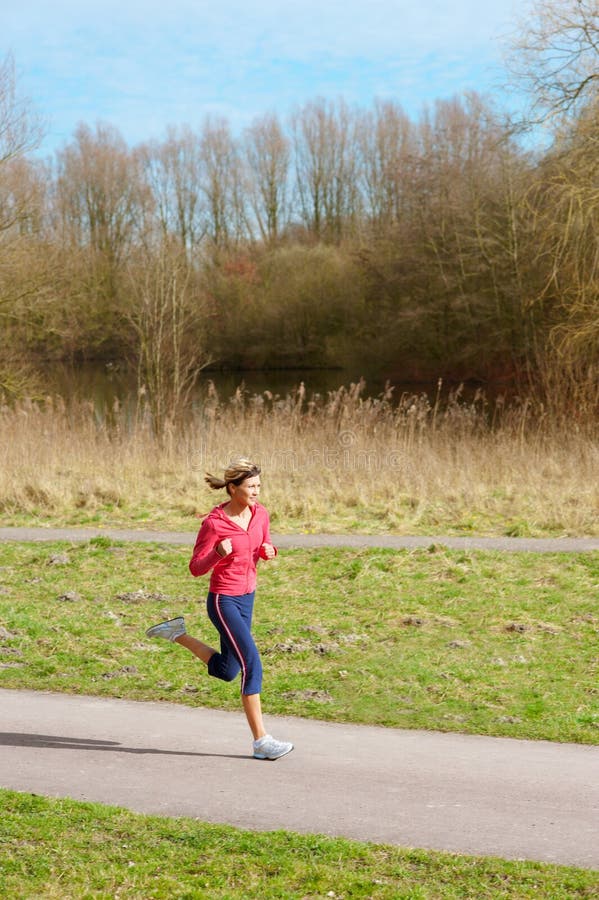 Lady Jogging in a Park stock photo. Image of active, beautiful - 13522682
