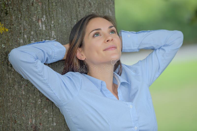 Lady Leaning Back Against Tree Trunk Stock Photo - Image of young ...