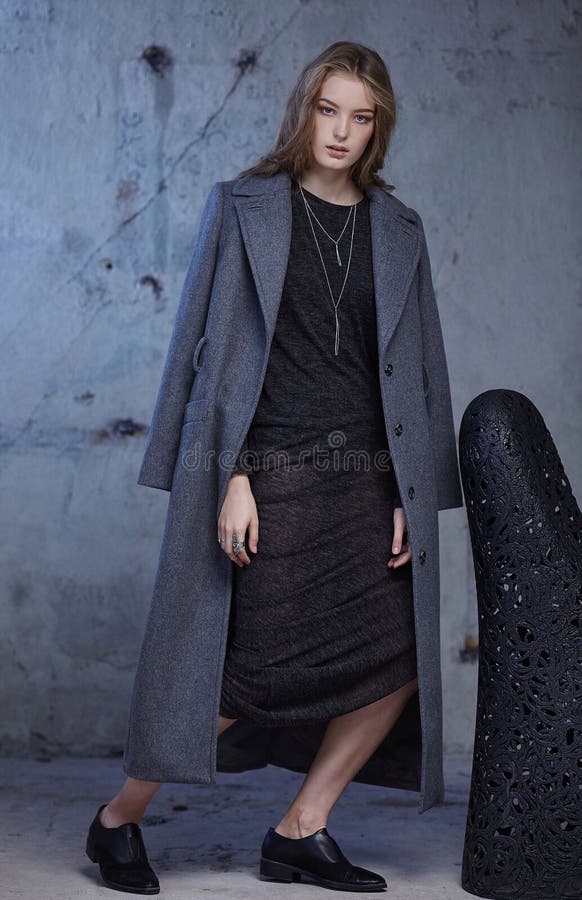 A Lady in a Long Grey Jacket. Stock Image - Image of heat, color: 112965187