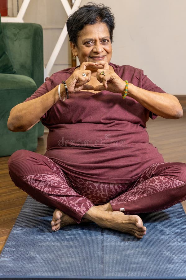 A Lady Making a Heart Pose on a Yoga Mat after a Happy Yoga Session ...