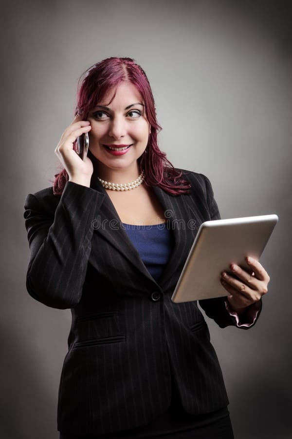 Lady multi tasking stock image. Image of work, tablet - 64863241
