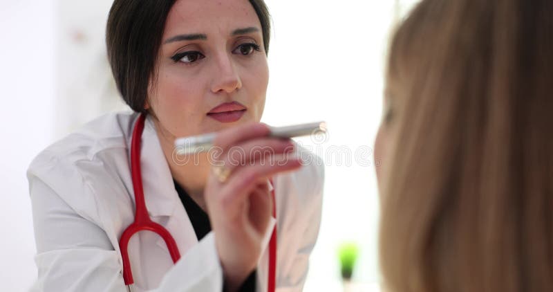 Female Doctor Examines Pupils of Patient Using Flashlight Stock Footage ...