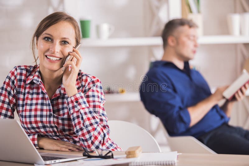 Lady on phone using laptop stock photo. Image of lifestyle - 77204438
