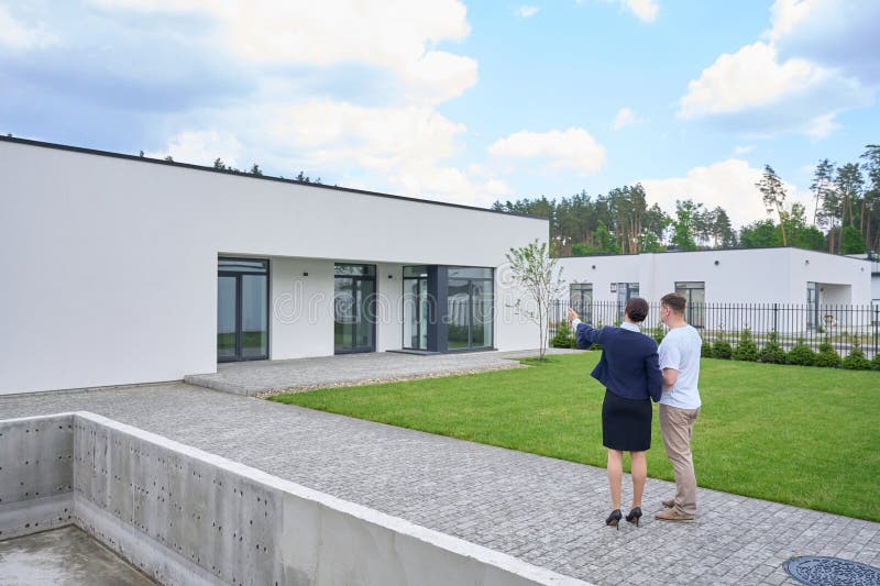 Lady Realtor with a Client Viewing a New House Stock Image - Image of ...