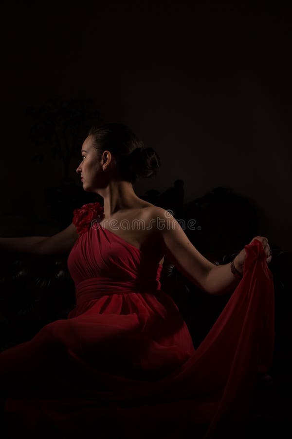 Lady in red in a dark room stock photo. Image of lady - 52812228