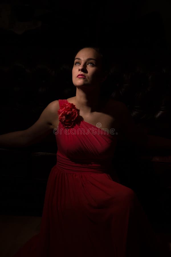 Lady in red in a dark room stock photo. Image of lady - 52812228
