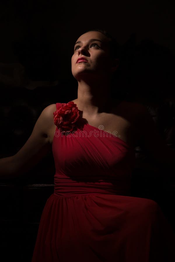 Lady in red in a dark room stock image. Image of ferventness - 52812351