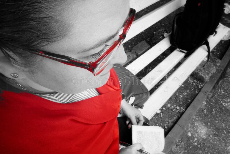 Lady in red reading stock image. Image of person, black - 231657931