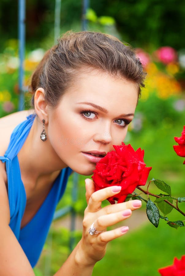 Woman smelling red roses stock photo. Image of hair, female - 41314794
