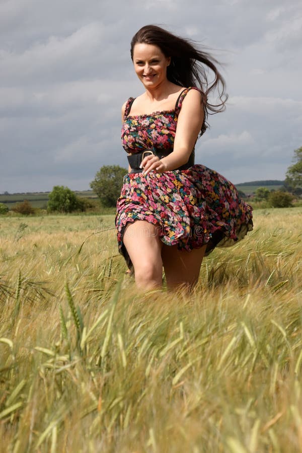 A Lady Running through a Corn Field Stock Photo - Image of trees ...