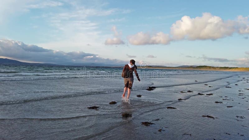 Silhouette of Lady Walking Down the Beach during Sunset Stock Footage ...