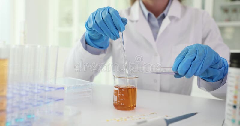 Female Scientist Blends Chemical Solution in Glass Beaker Stock Video ...