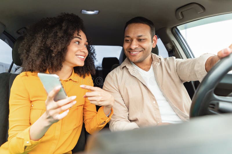 Lady Showing Application on Cellphone To Driver Guy in Car Stock Photo ...