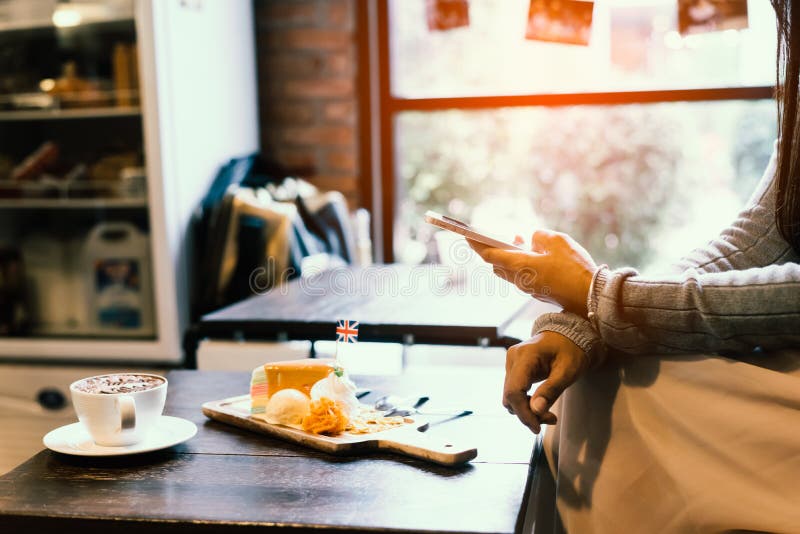 The Lady Sit and Relax in the Cafe, Holding the Phone in Hand Stock ...