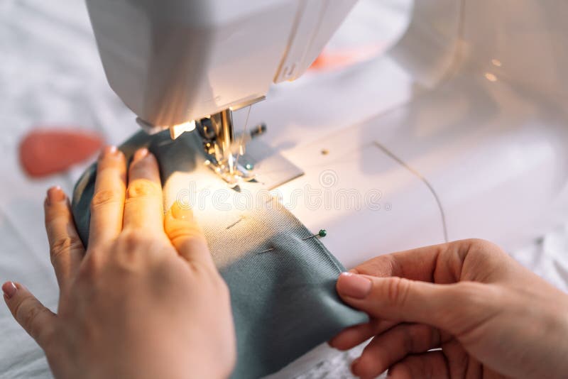 Lady Stitching the Edges of the Fabric of a Sewing Machine Stock Photo ...