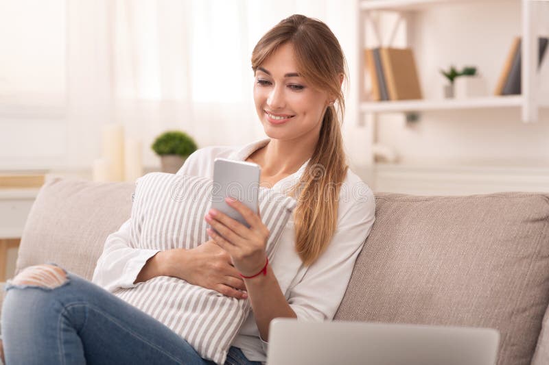 Lady Texting on Smartphone Sitting on Sofa at Home Stock Image - Image ...