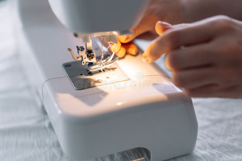 Lady Threading a Sewing Machine Needle Stock Photo - Image of tailoring ...