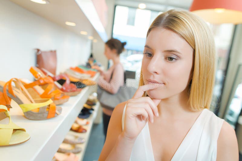 Lady Trying To Decide on Pair Shoes Stock Photo - Image of ...