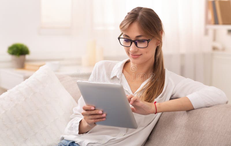 Lady Using Digital Tablet Sitting on Couch Indoor Stock Image - Image ...