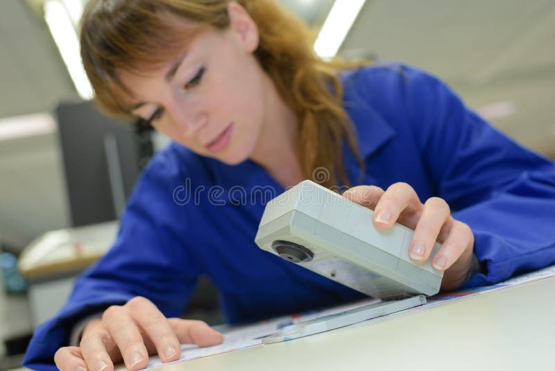 Lady Using Hand Held Machine Stock Photo - Image of device, handheld ...