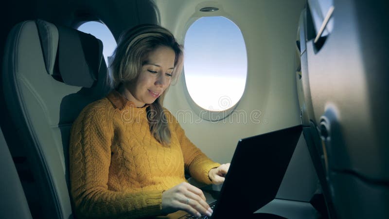 Female Passenger Working Inside of an Airplane. a Lady in the Aircraft ...