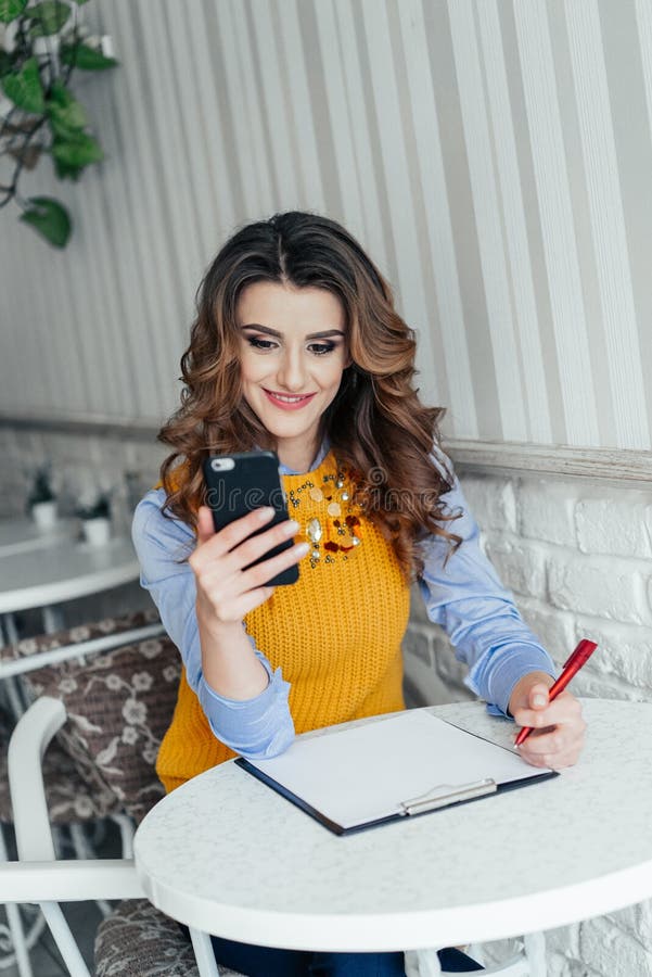 Lady using phone in a cafe stock photo. Image of blue - 68090810