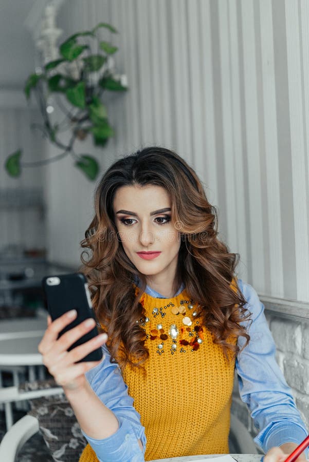 Lady using phone in a cafe stock image. Image of money - 68090997