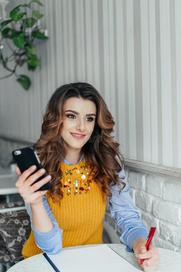Lady using phone in a cafe stock photo. Image of people - 68091192