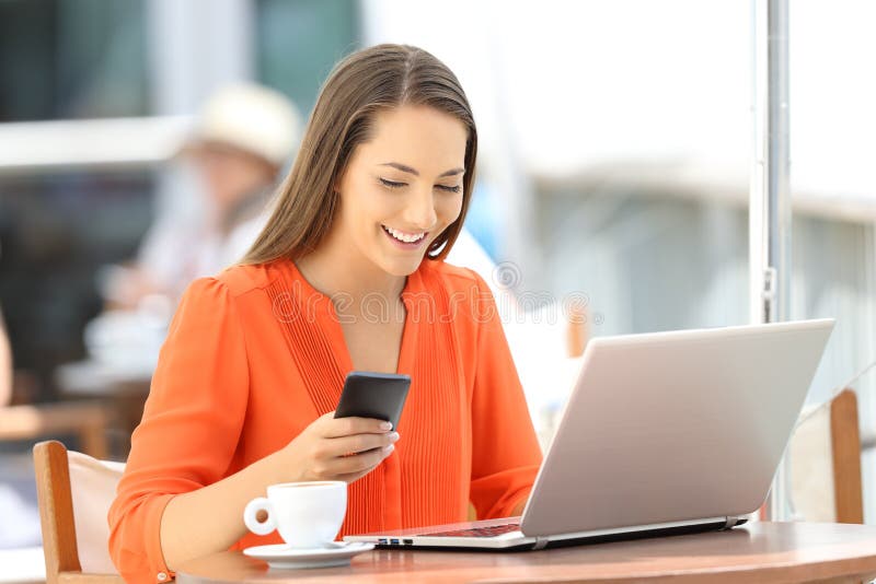 Lady Using a Phone and Laptop in a Bar Stock Photo - Image of browsing ...