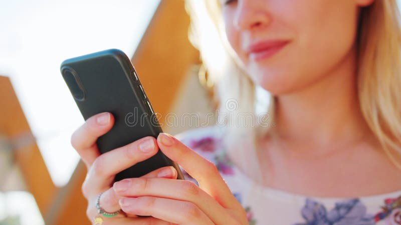 Lady Using a Phone Outdoors Stock Image - Image of hand, black: 153556669